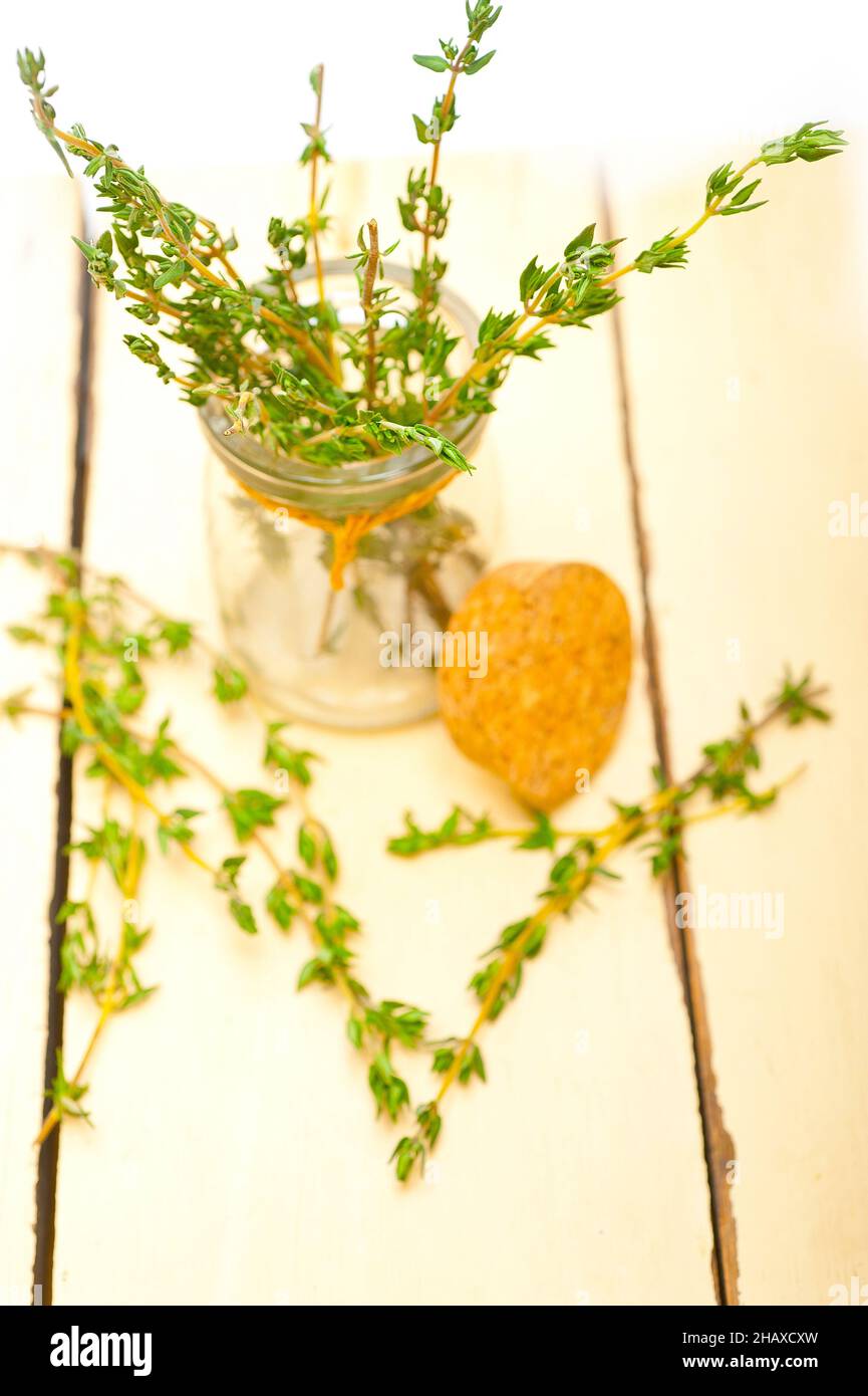 fresh thyme on a glass jar over a white wood rustic table Stock Photo ...