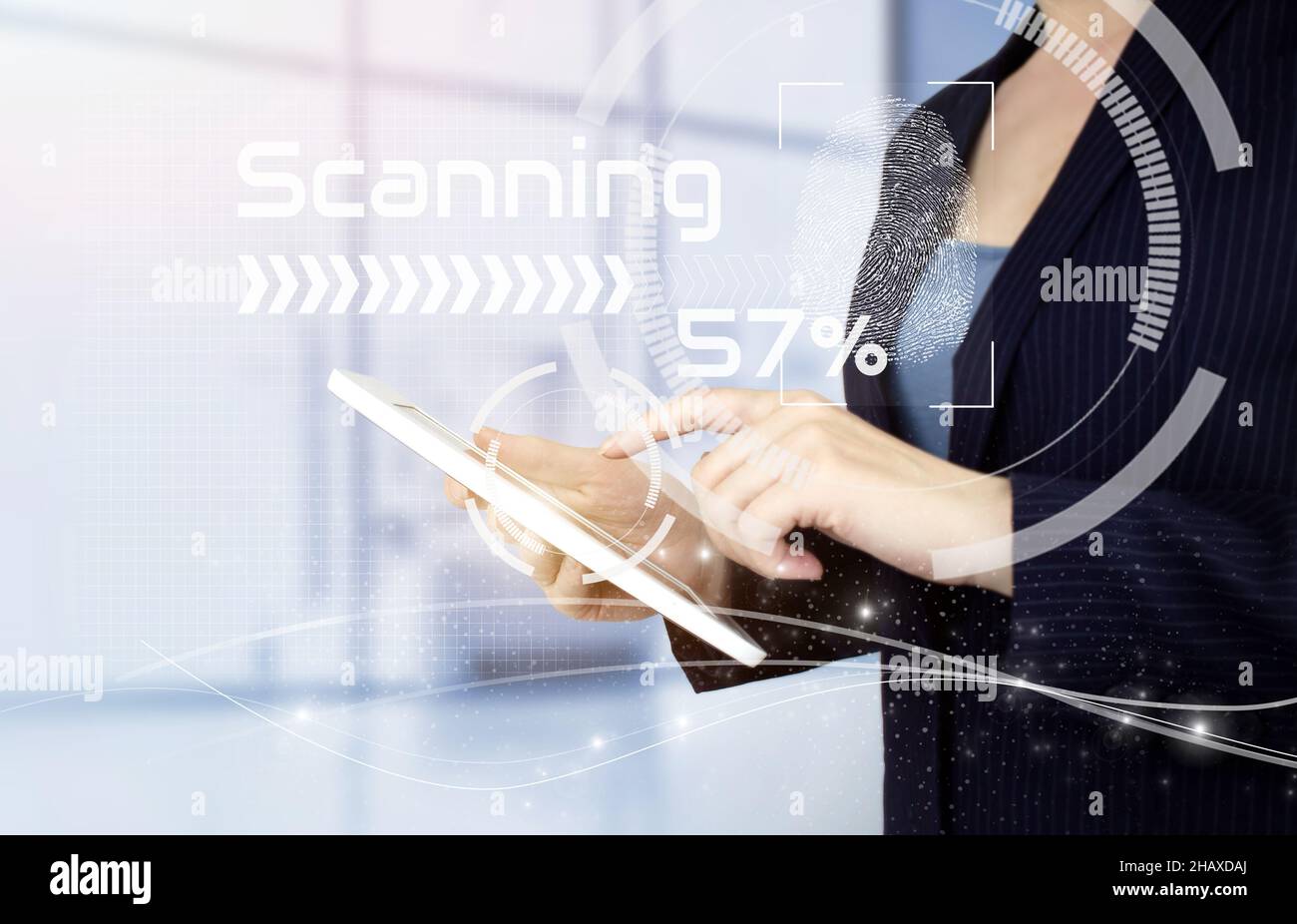 Hand touch white tablet with digital hologram scanner sign on light ...