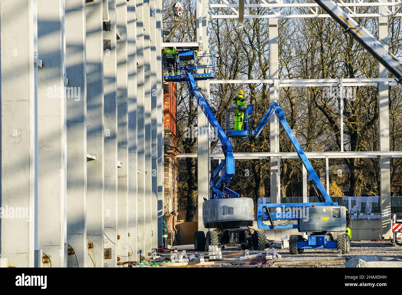 self propelled scissor platforms with workers in uniform and safety ...