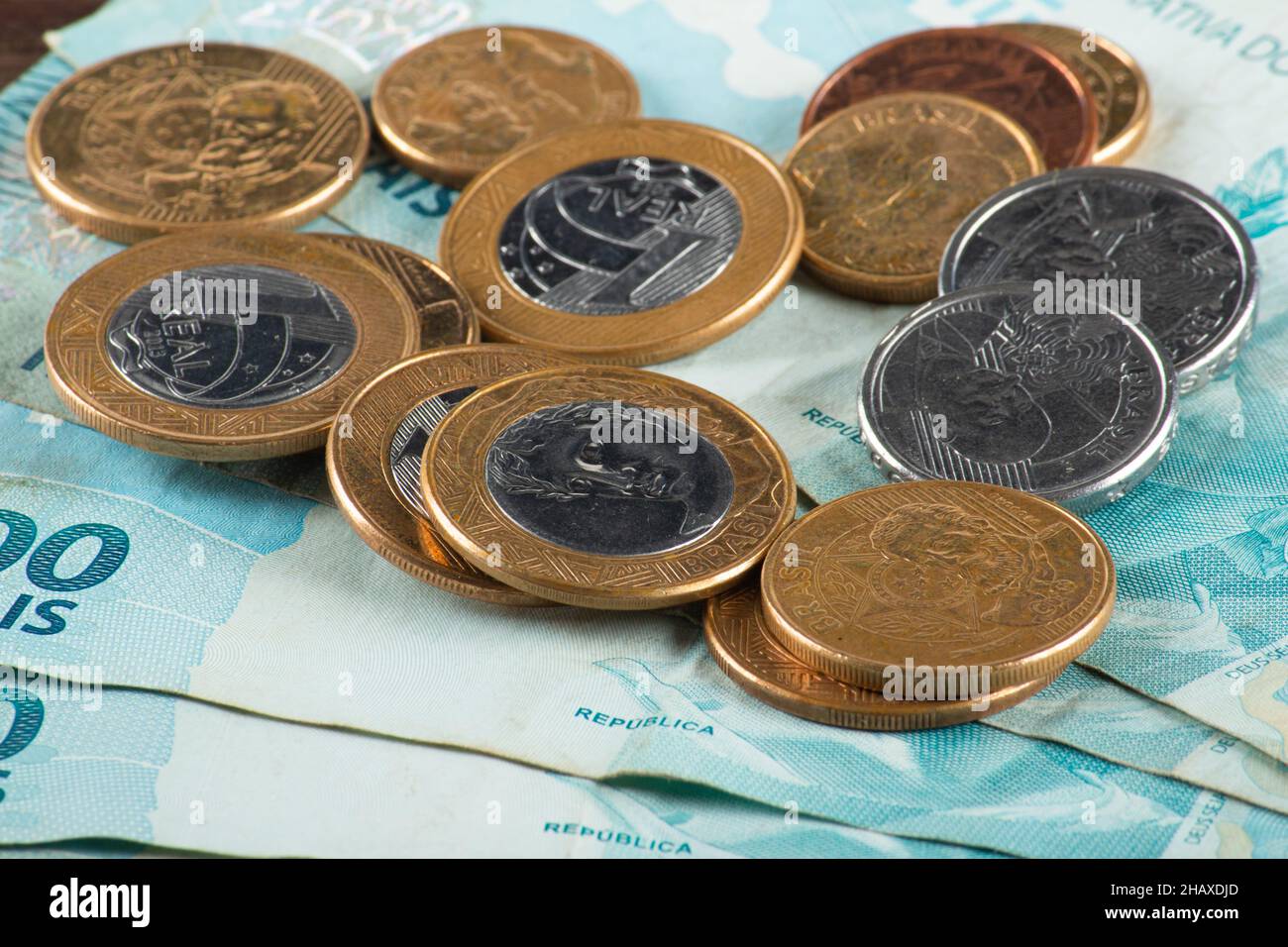 Real currency, money from Brazil. 100 reais bills with Brazilian coins ...