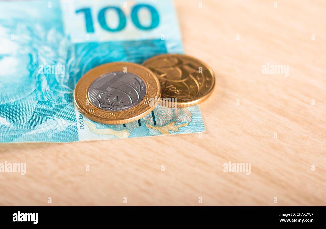 Real currency, money from Brazil. 100 reais bills with Brazilian coins ...