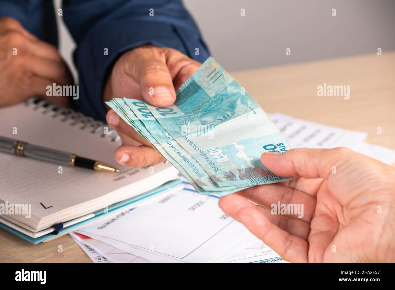 Businessman giving money to his partner when making contract. business ...