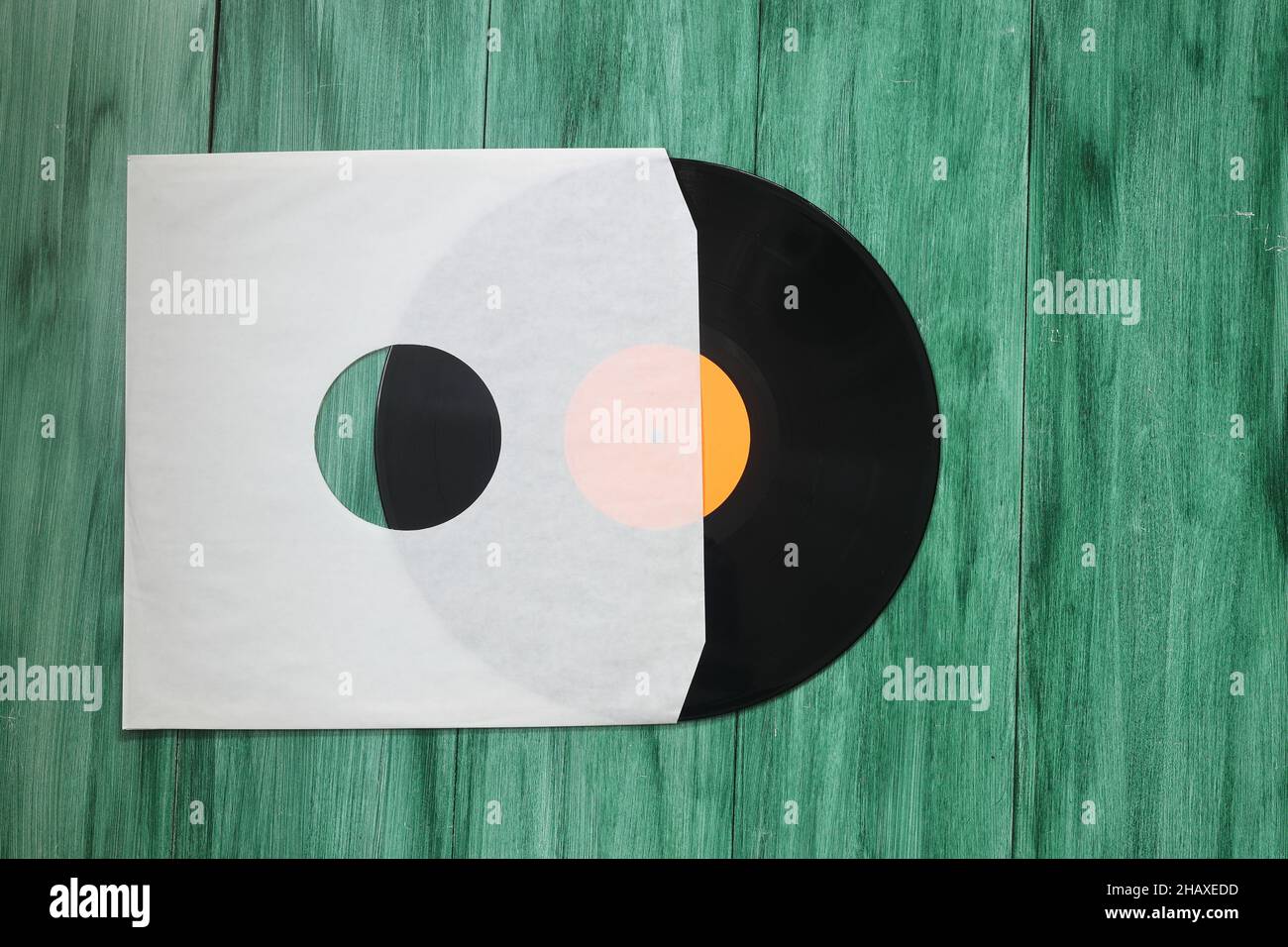 Aged White paper cover and vinyl LP record isolated on rusty background ...