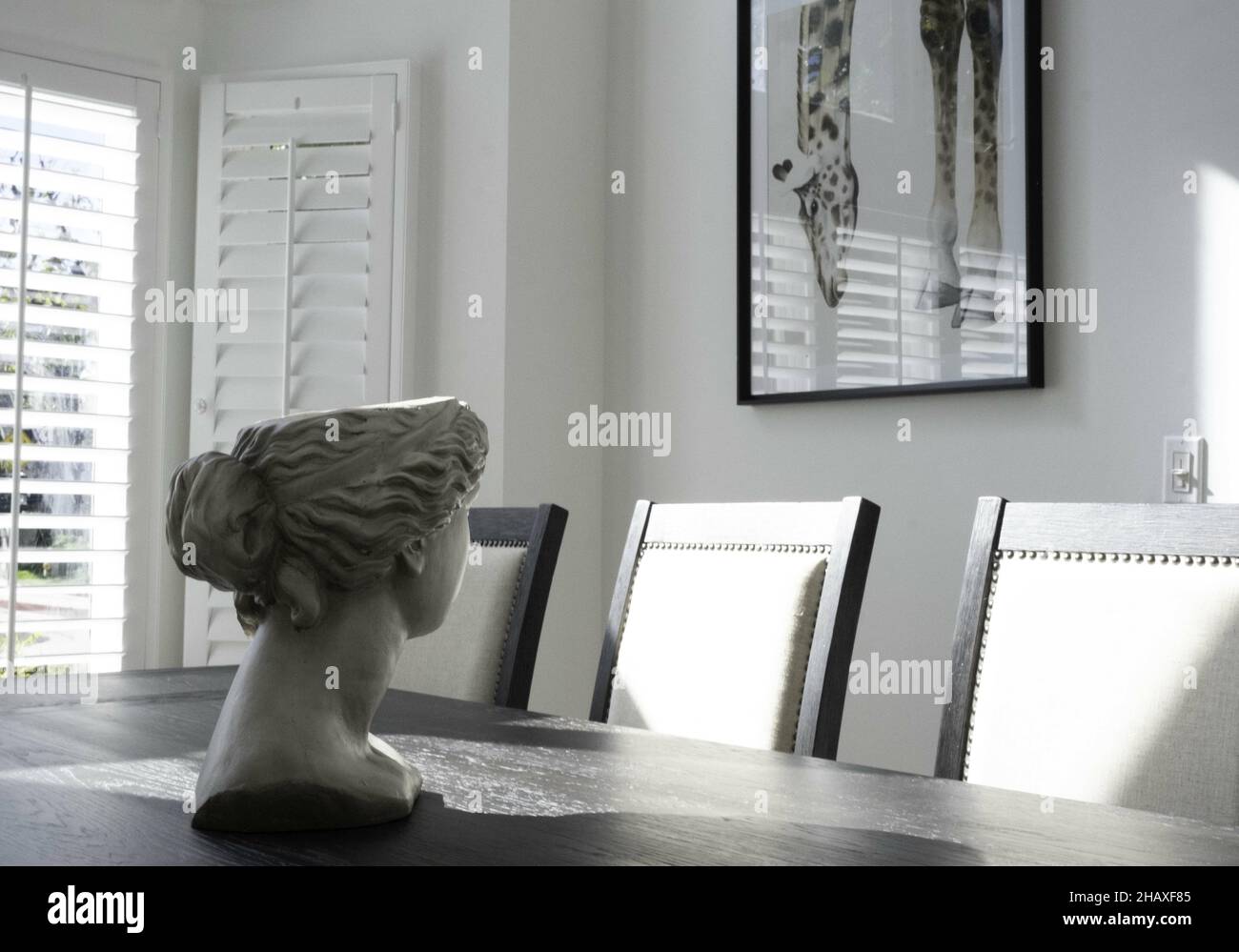 Grayscale shot of a modern house interior design with a female head ...