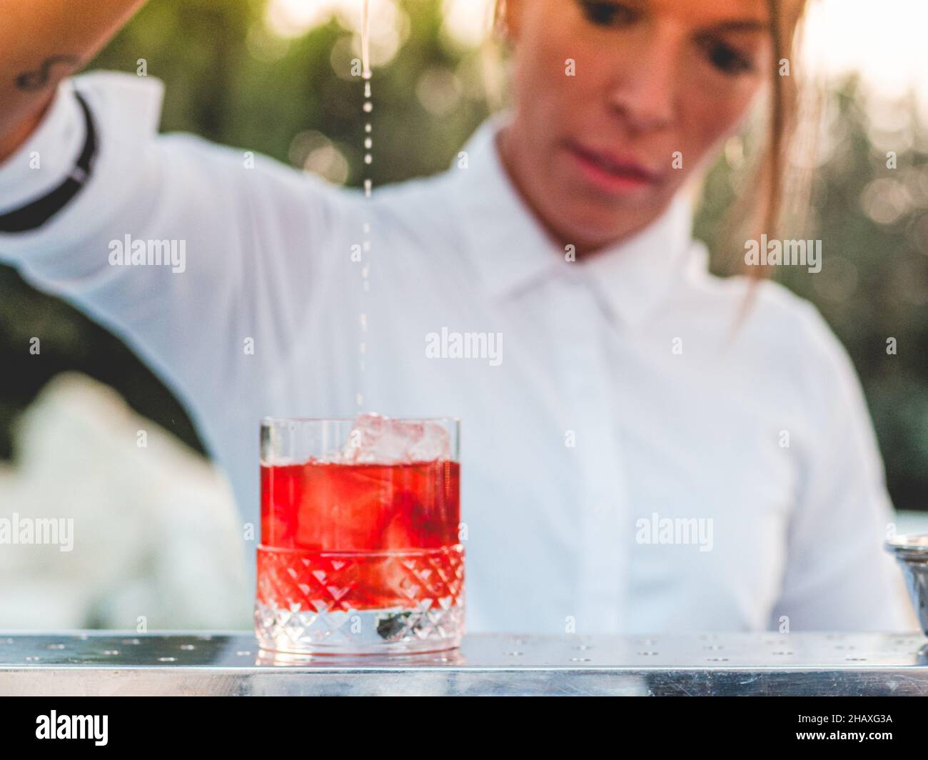 MILANP, ITALY - Nov 04, 2021: A young Caucasian young female bartender ...