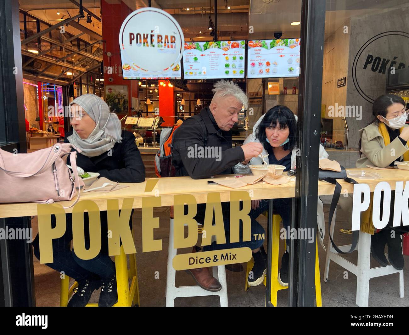 People eat at a Poke' Bar by the window in Manhattan, New York City ...