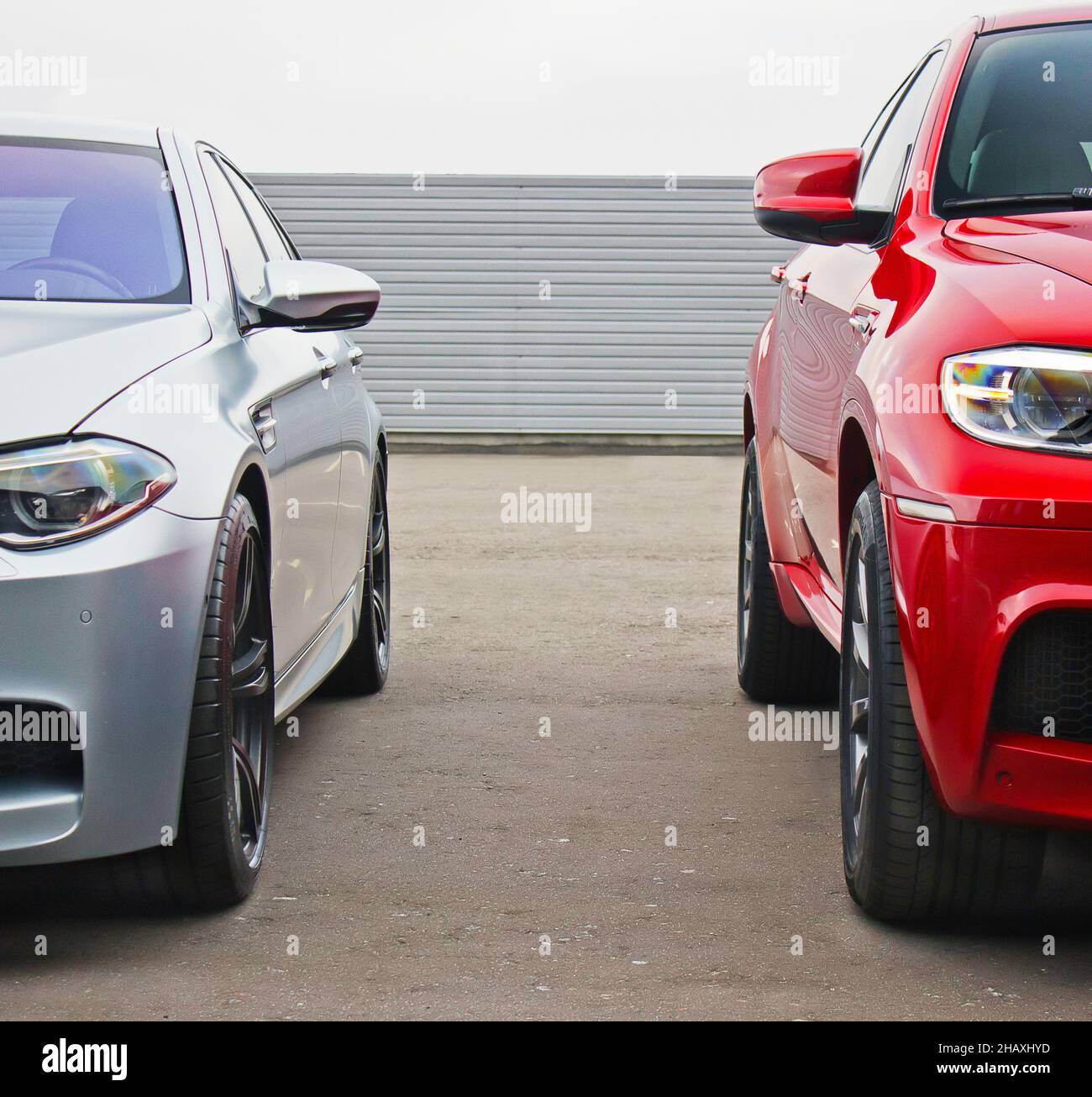 Two beautiful cars on the background of the fence Stock Photo - Alamy