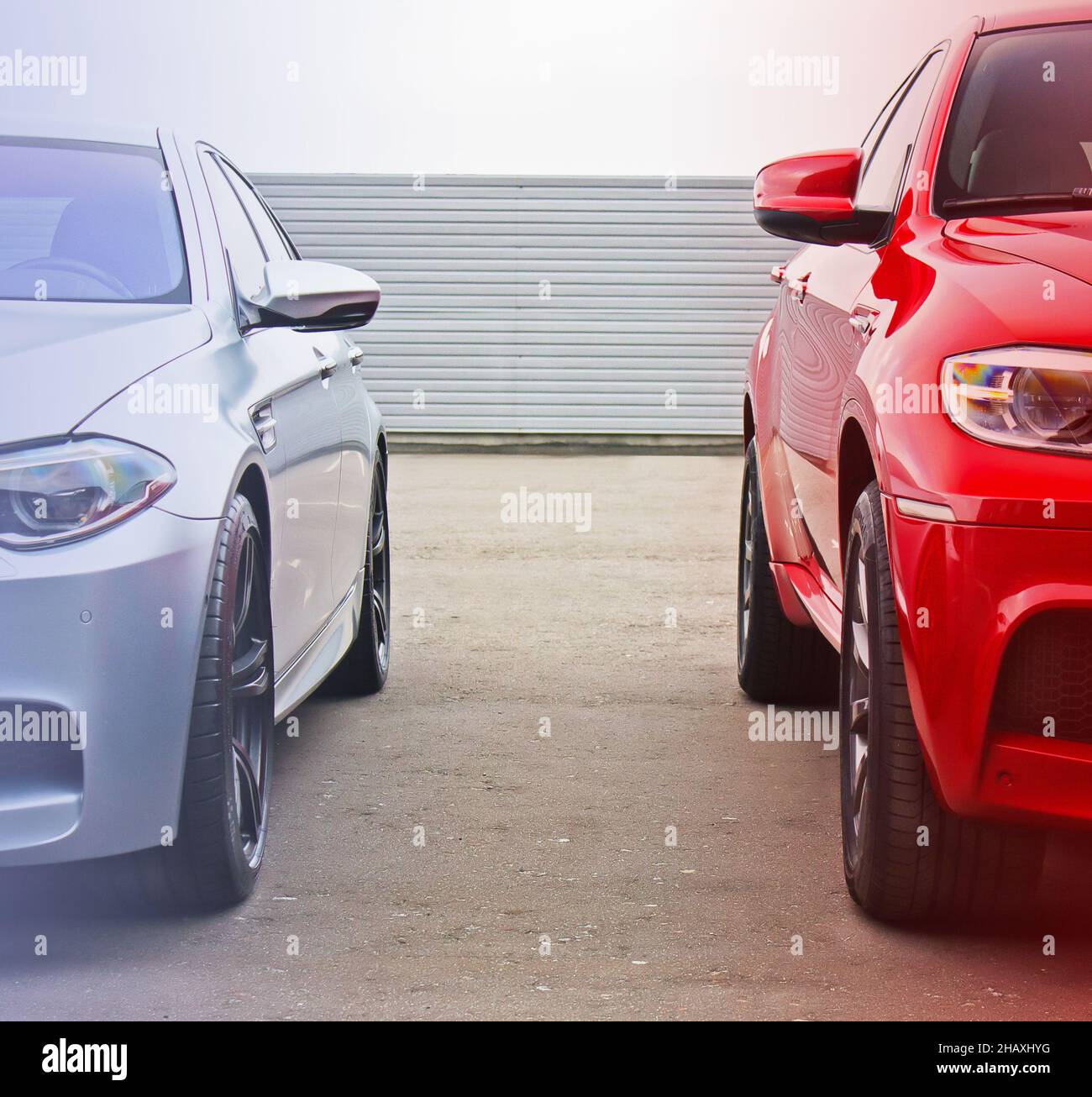Two beautiful cars on the background of the fence Stock Photo - Alamy