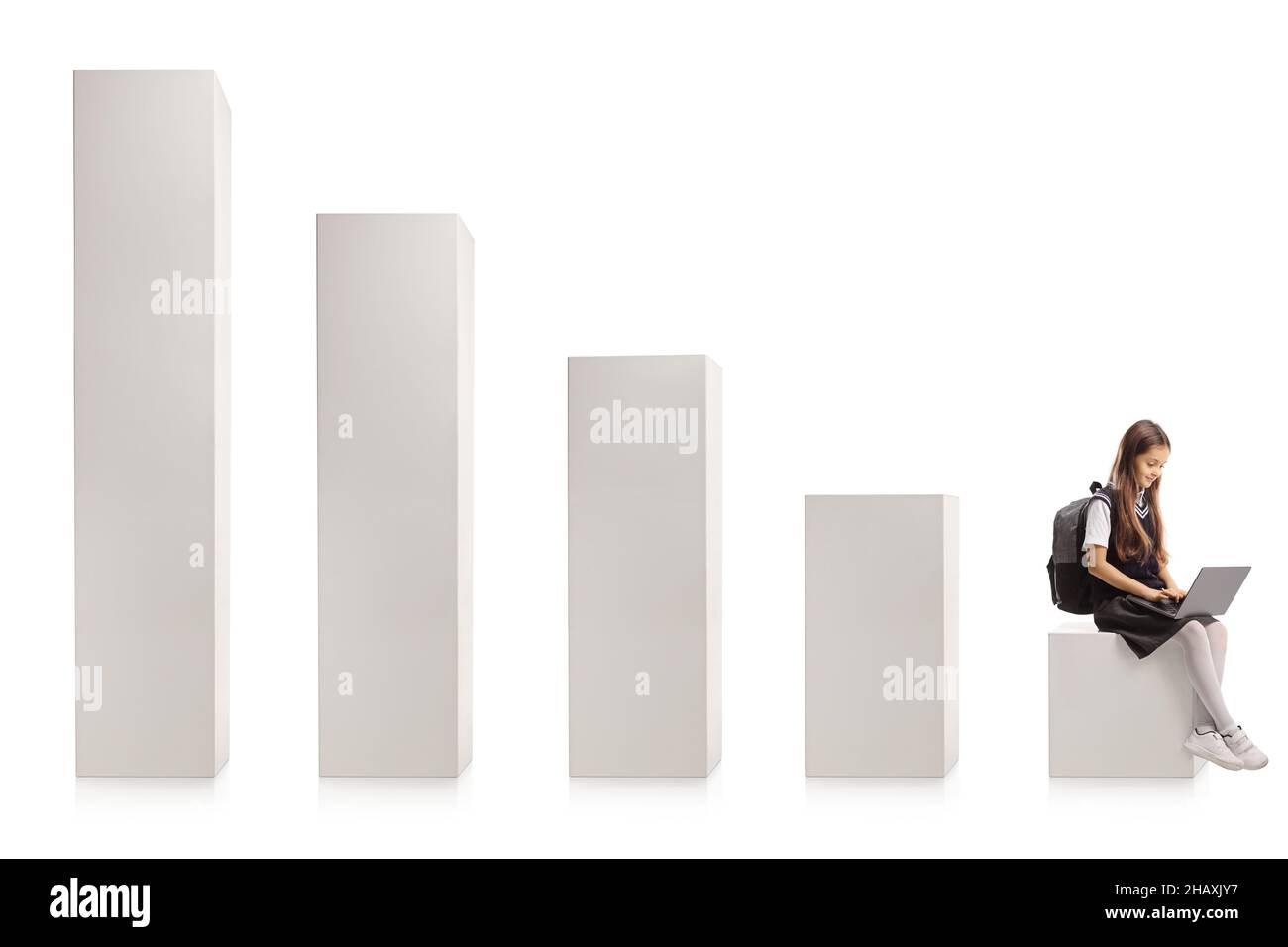 Schoolgirl with a laptop computer sitting on a bar chart isolated on ...