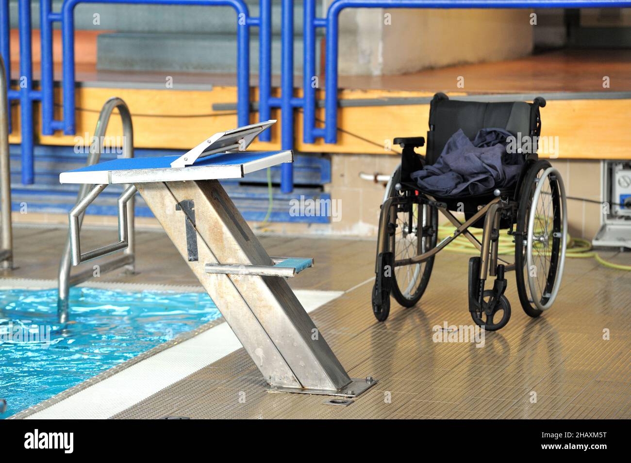 Wheelchair near the starting block of a swimming pool Stock Photo - Alamy