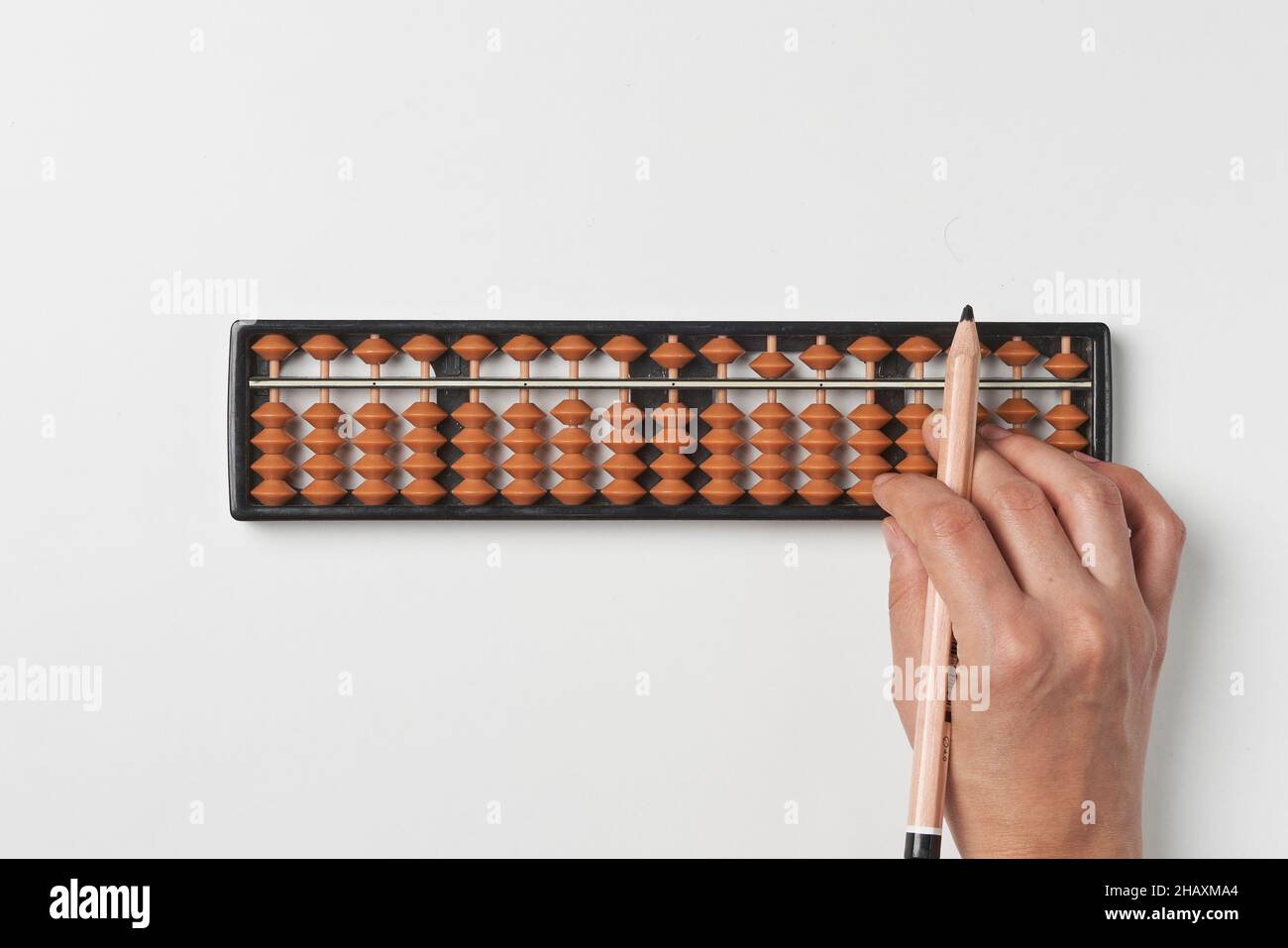 Doing mental math or mental arithmetic. Hand of person using abacus for ...