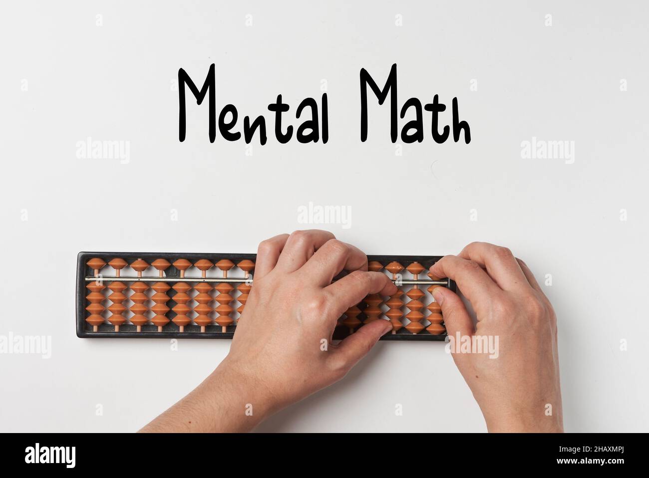 Doing mental math or mental arithmetic. Hand of person using abacus for ...
