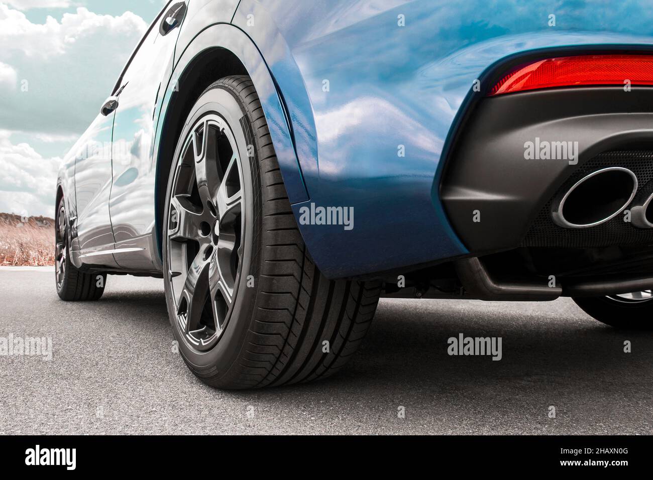 Car on sky background. Car wheels close up on a background of asphalt ...