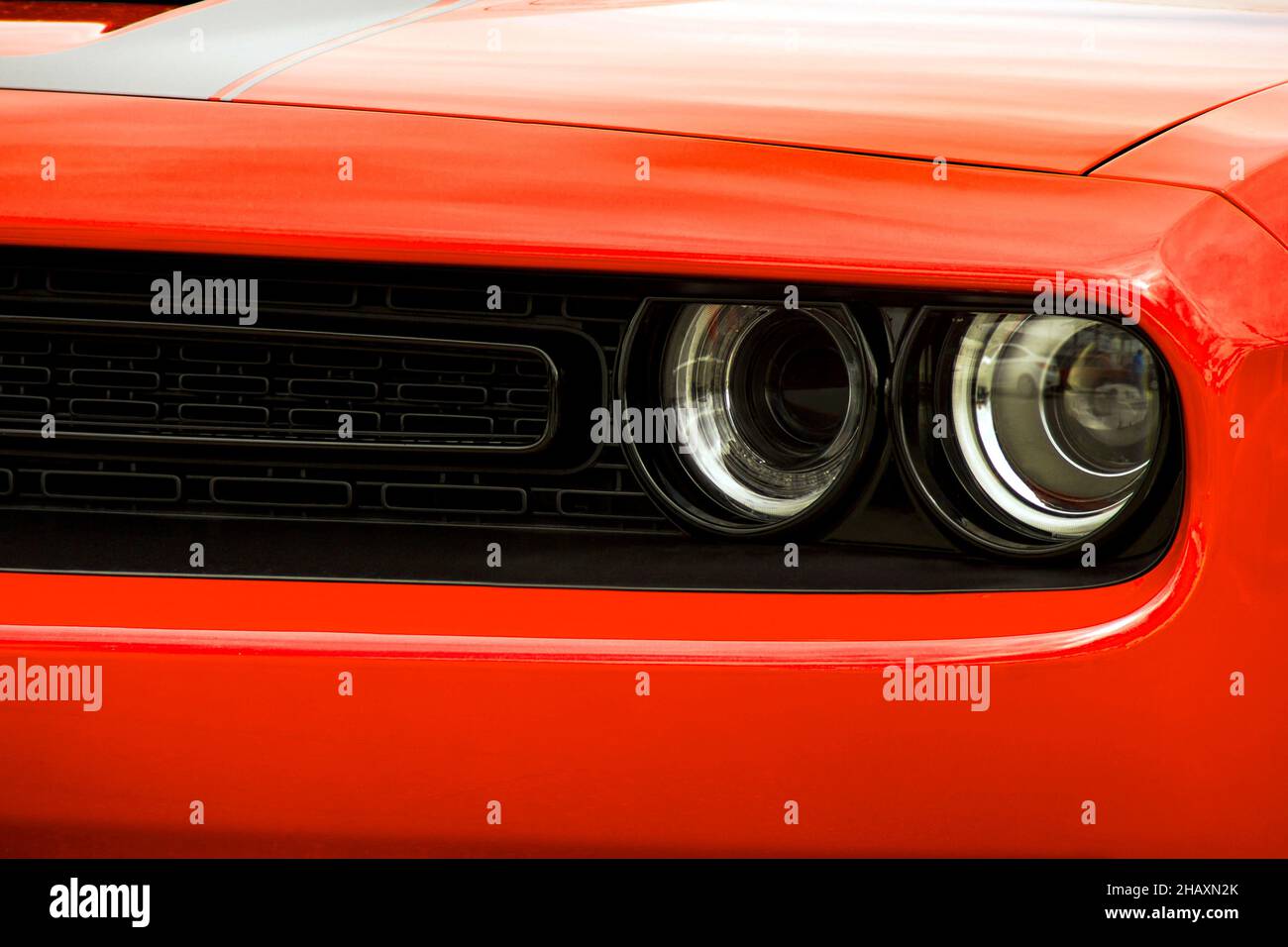 Car headlights. Luxury Headlights. Front of the car close up. Red car ...
