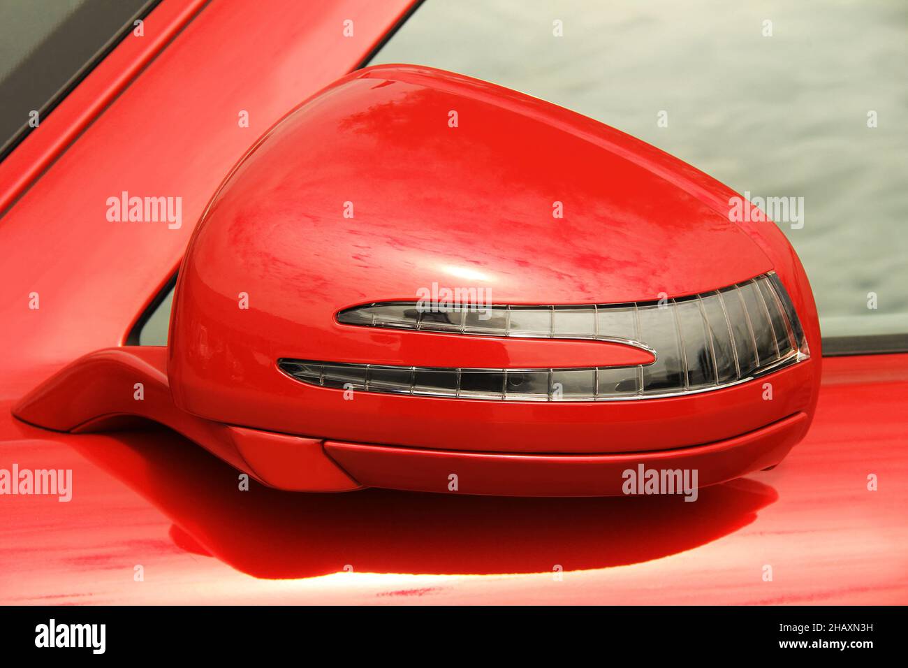 Car rearview mirror. Part of a red car. Car parts Stock Photo - Alamy