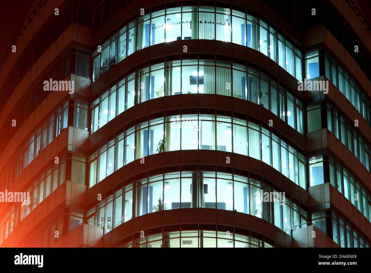 The facade of a round glass building with large panoramic windows and ...