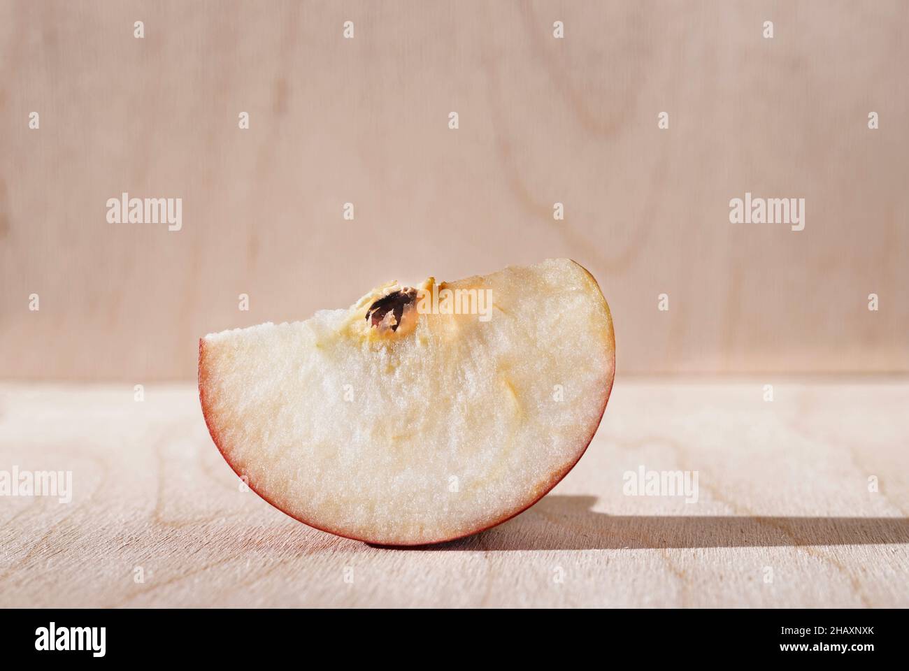 Slice of red Annurca apple on wooden background ,fruit cultivated in ...