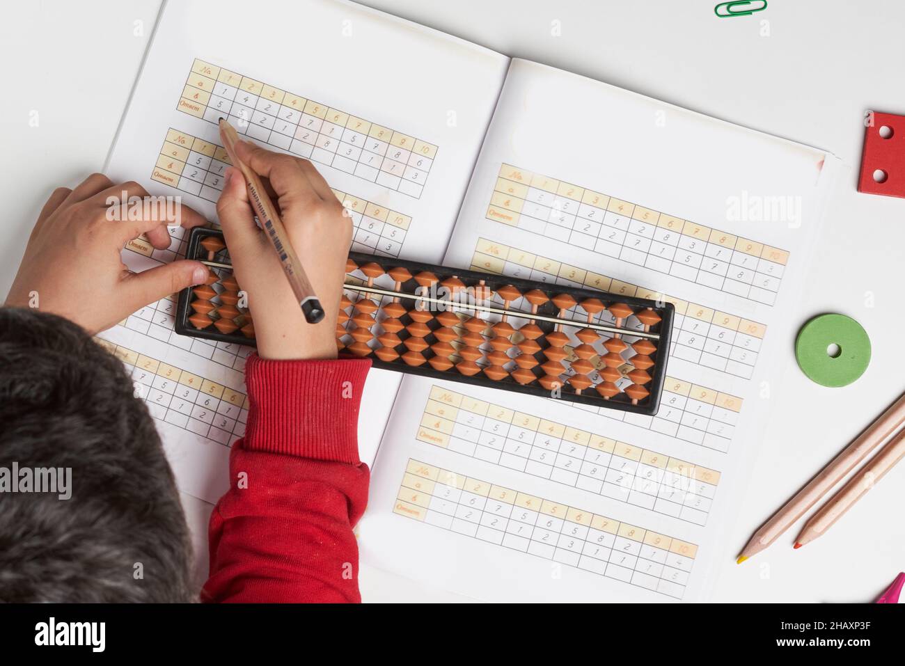 Doing mental math or mental arithmetic. Hand of little boy using abacus ...