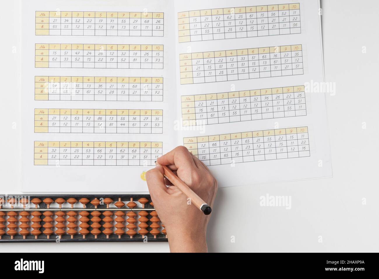 Doing mental math or mental arithmetic. Hand of person using abacus for ...