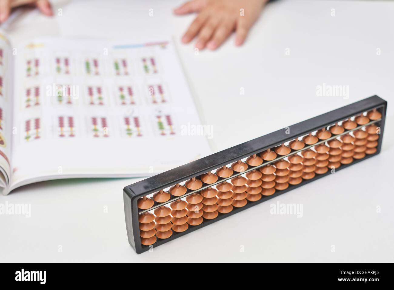 Doing mental math or mental arithmetic. Hand of little boy using abacus ...