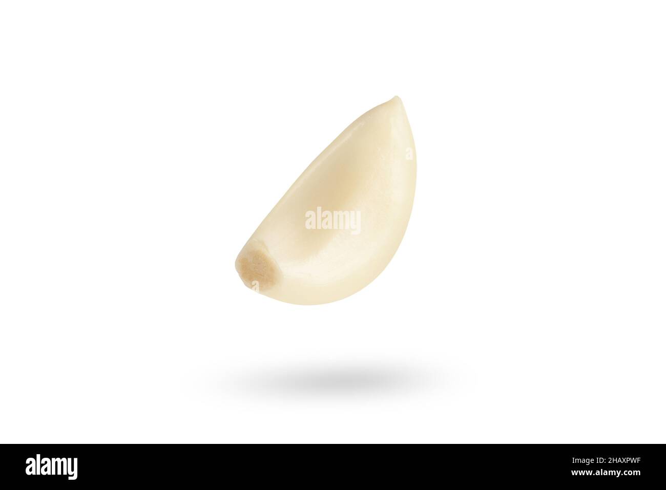 Garlic on a white background. Falling peeled clove of garlic falling on ...