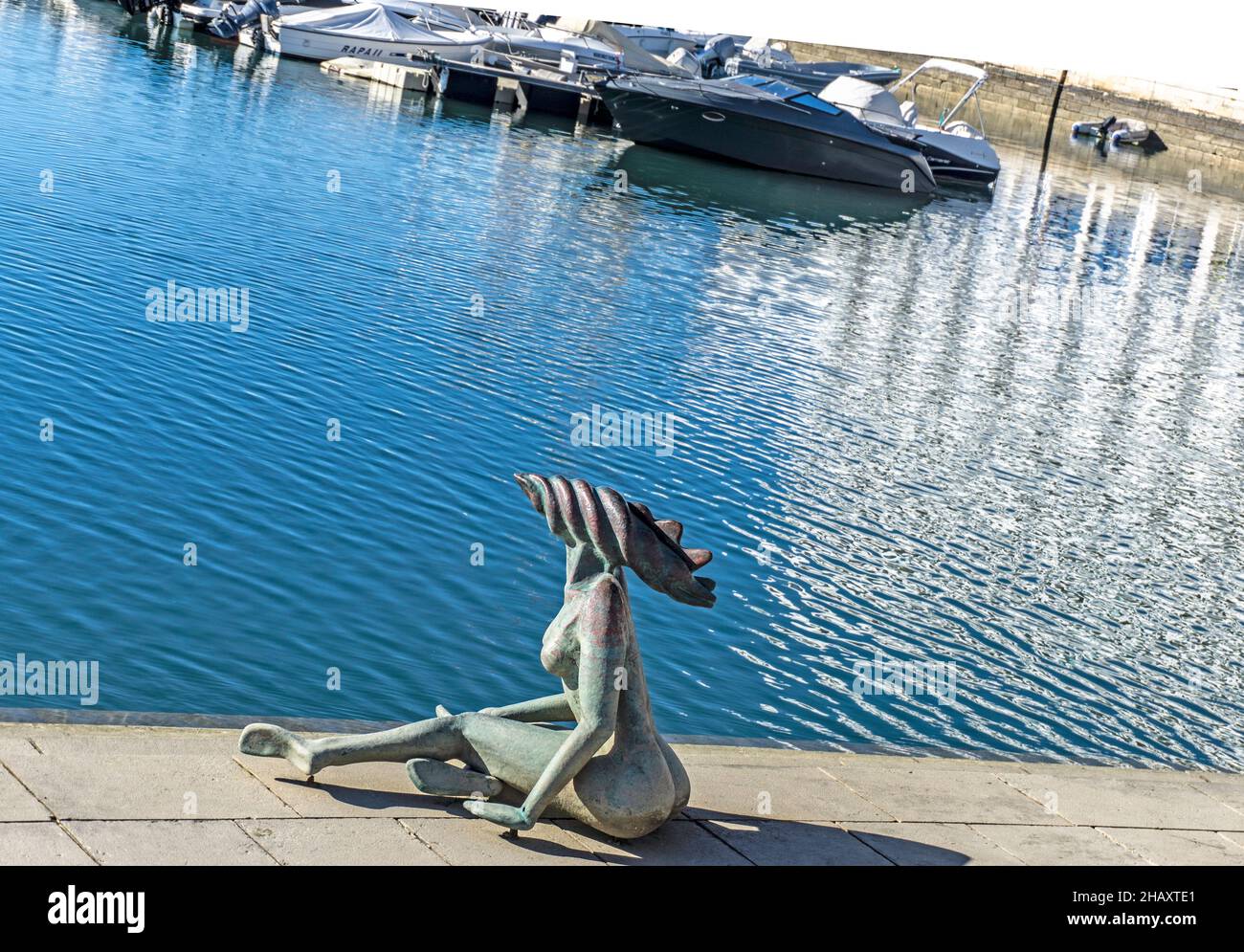 The statue of a mermaid sitting in the port of Faro, Portugal Stock ...