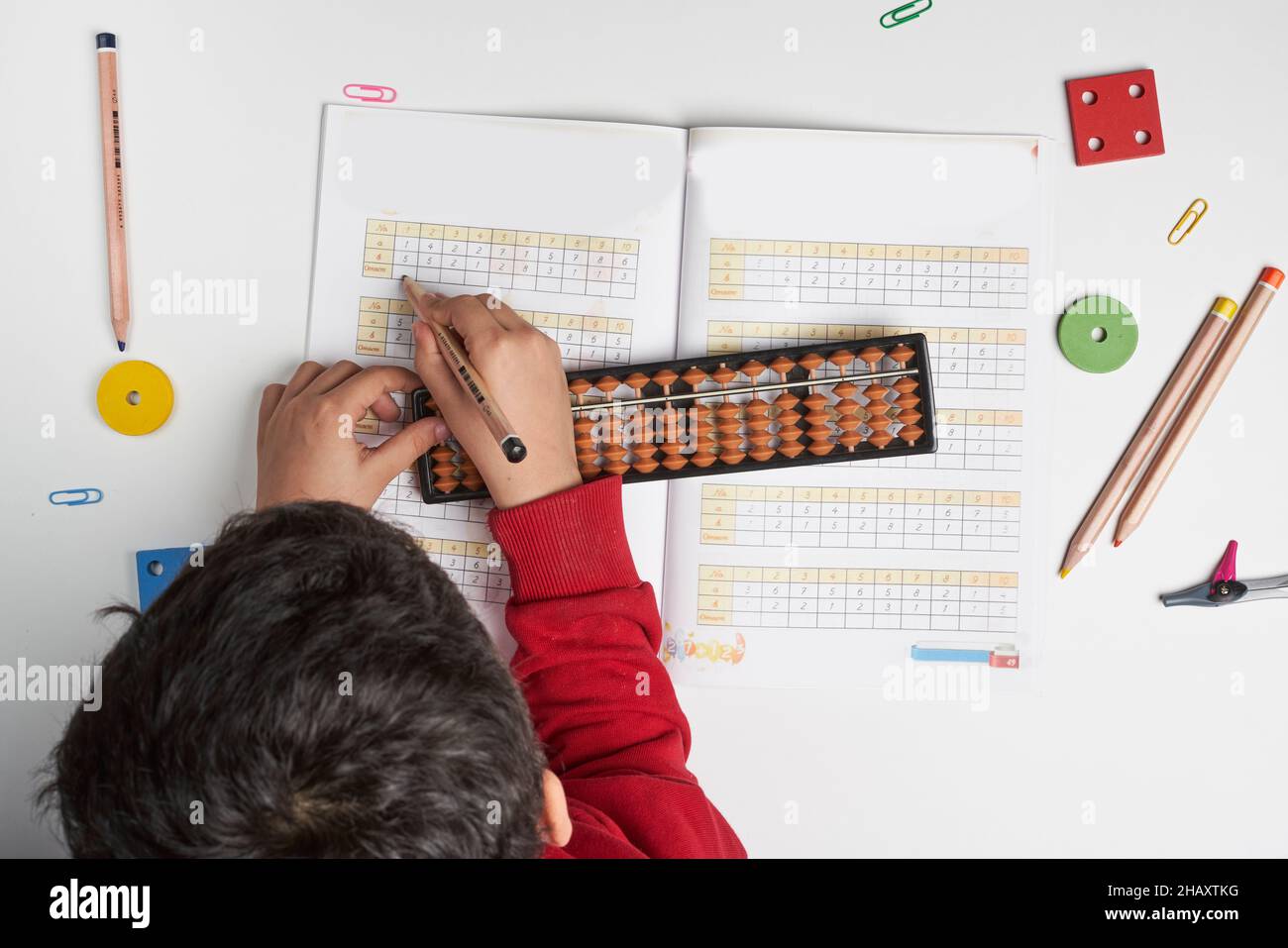 Doing mental math or mental arithmetic. Hand of little boy using abacus ...