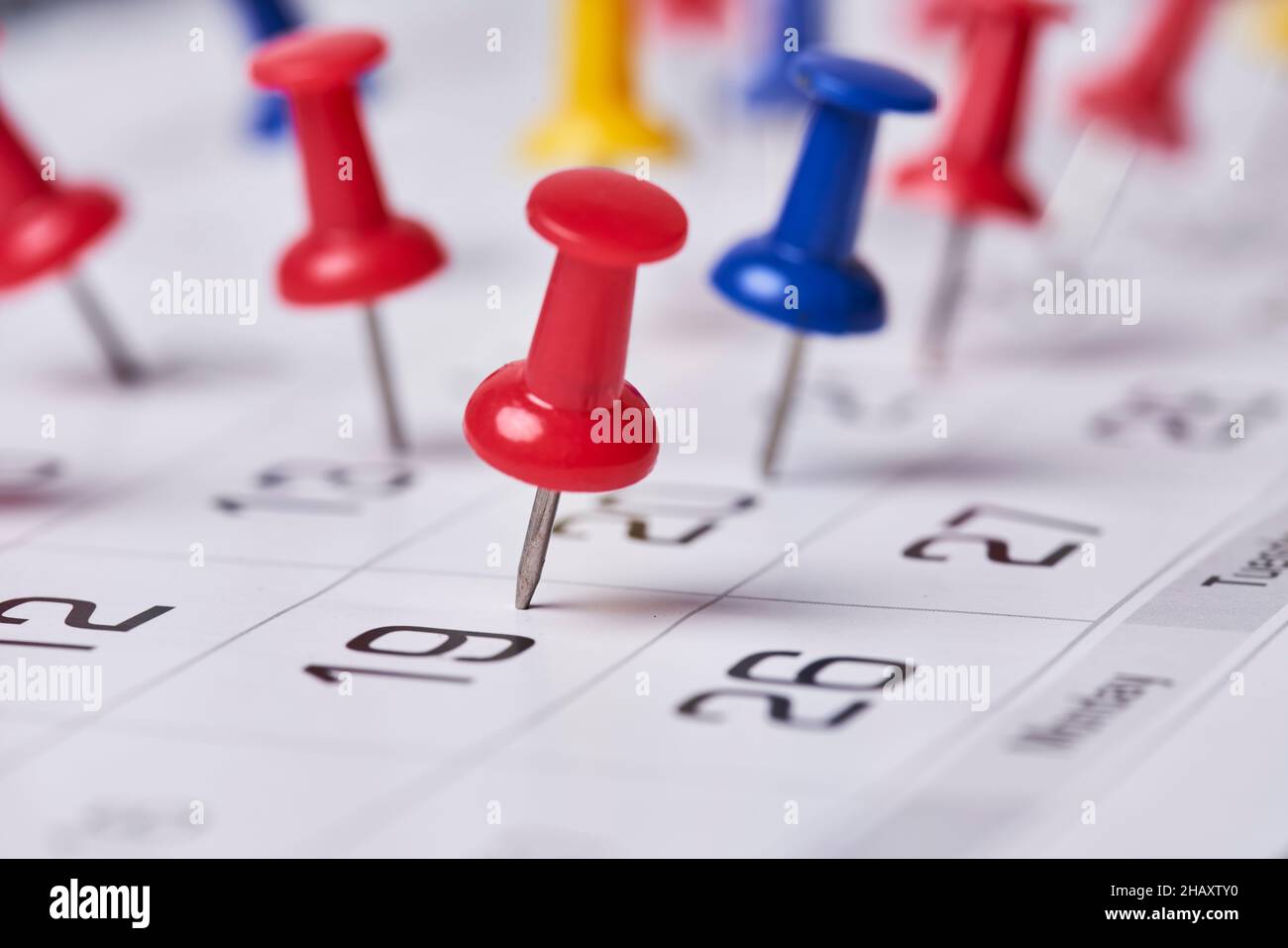 Colored push pins on monthly calendar page. Calendar appointments ...