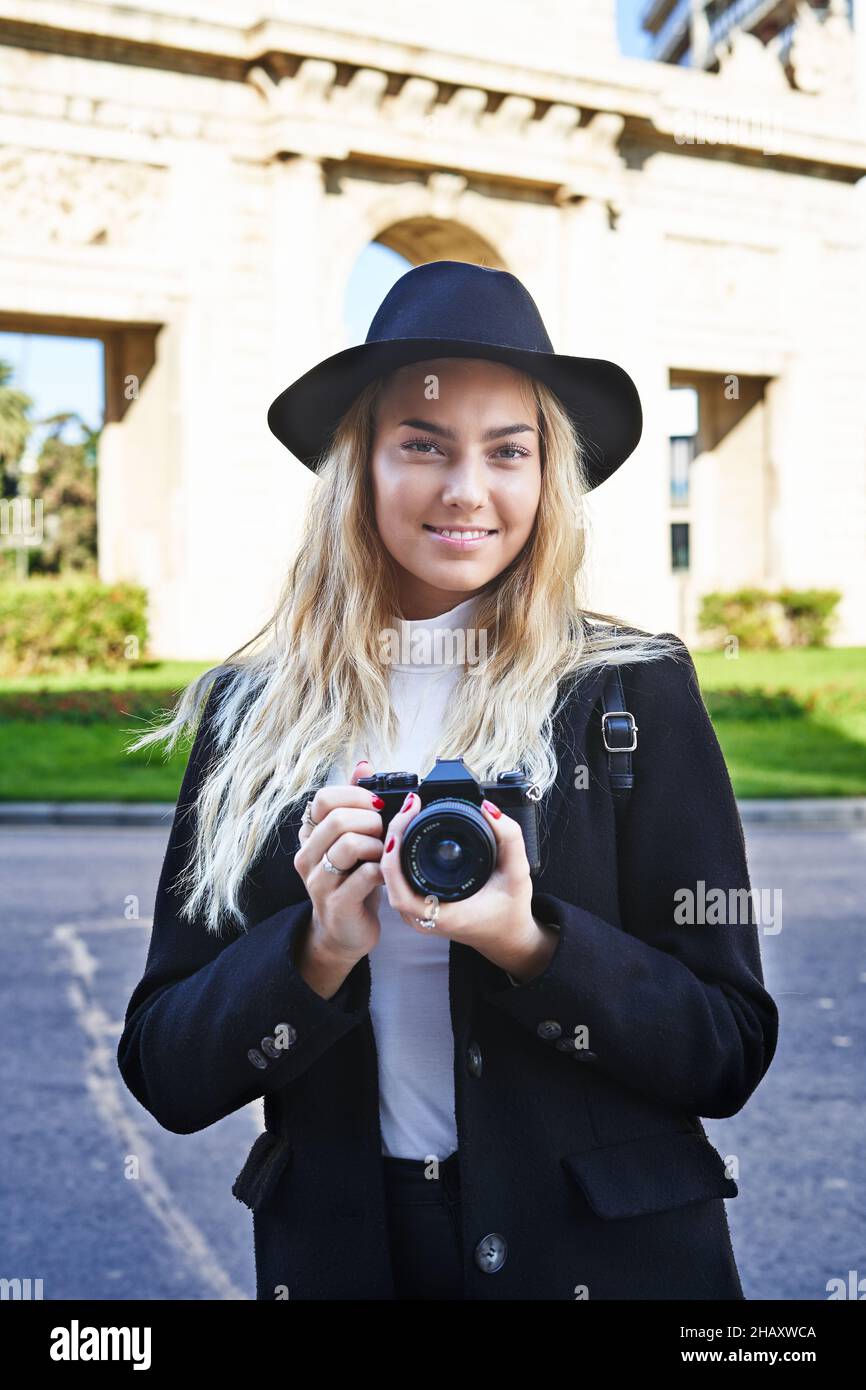Crop anonymous male chef with raw poultry standing near table with bowl ...