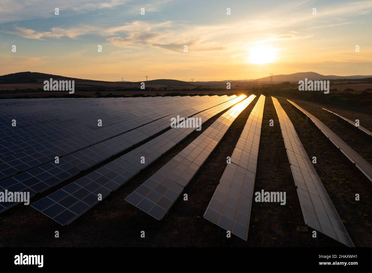 Solar panel farm under sunset sky reflecting light Stock Photo - Alamy