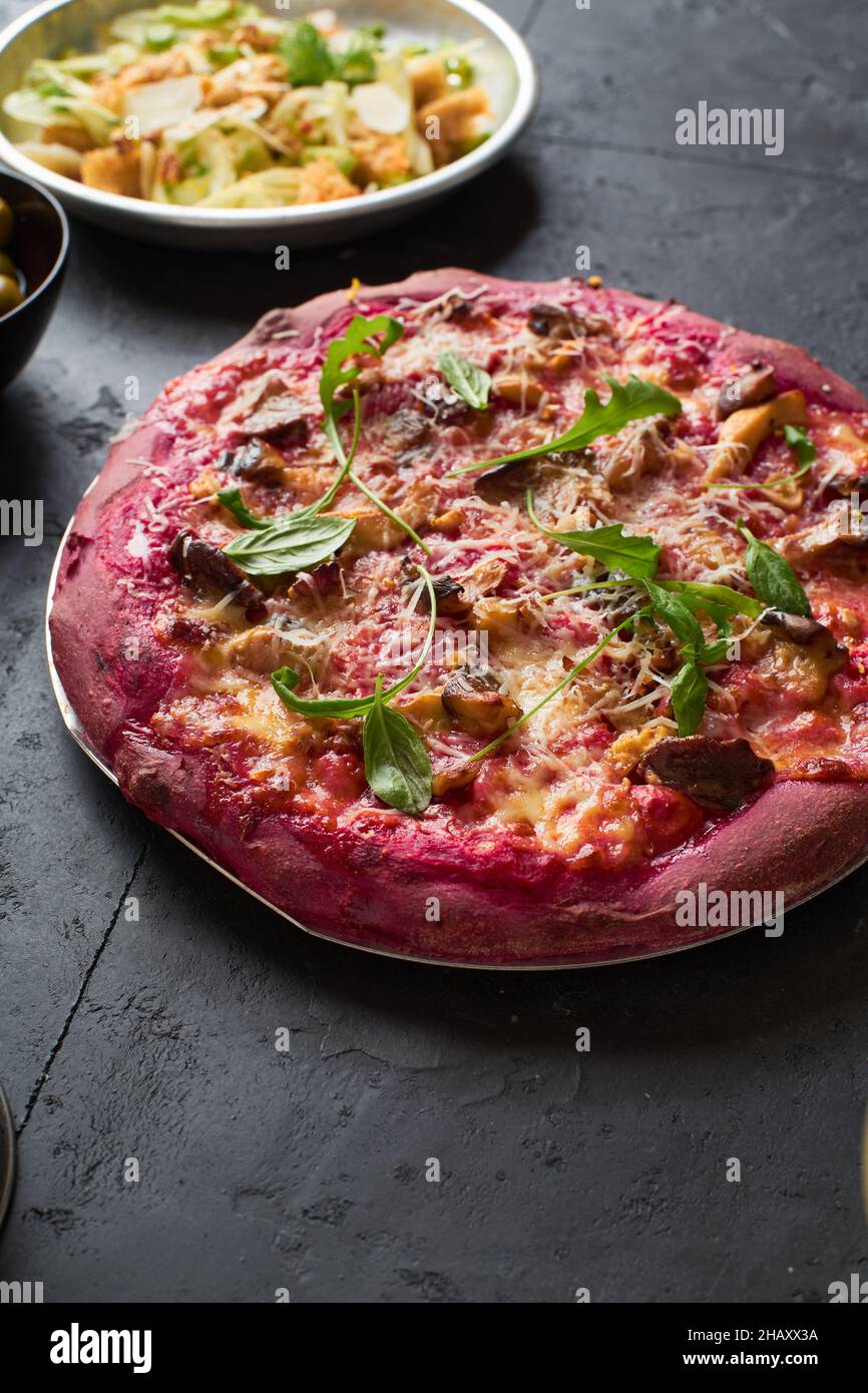 Purple colored rustic pizza with beetroot and vegetarian topping. Top ...