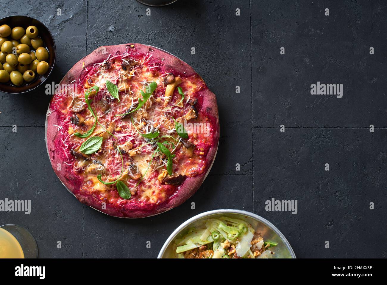 Purple colored rustic pizza with beetroot and vegetarian topping. Top ...