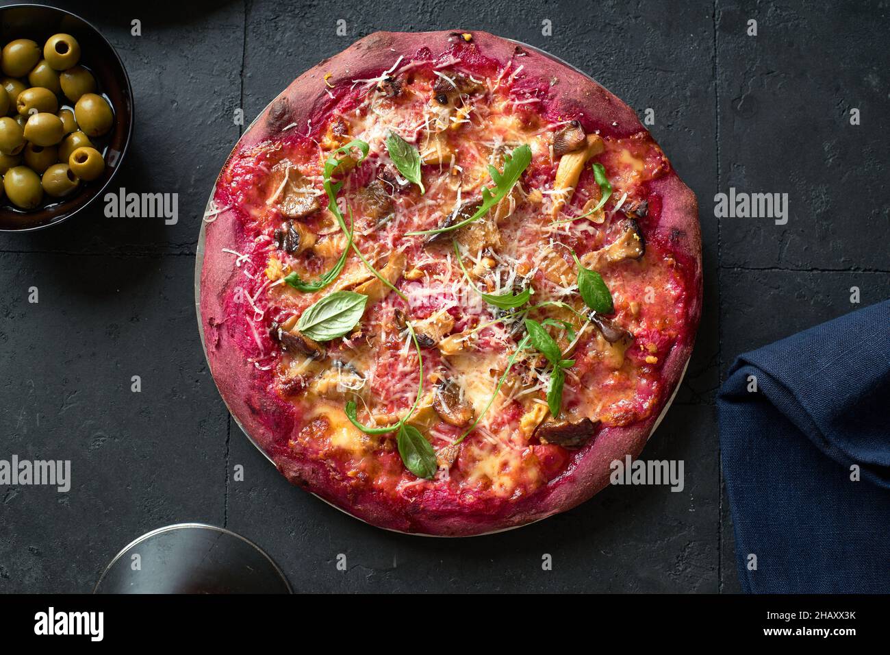 Purple colored rustic pizza with beetroot and vegetarian topping. Top ...