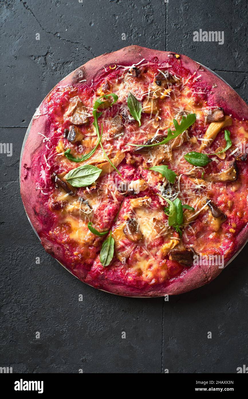 Purple colored rustic pizza with beetroot and vegetarian topping. Top ...