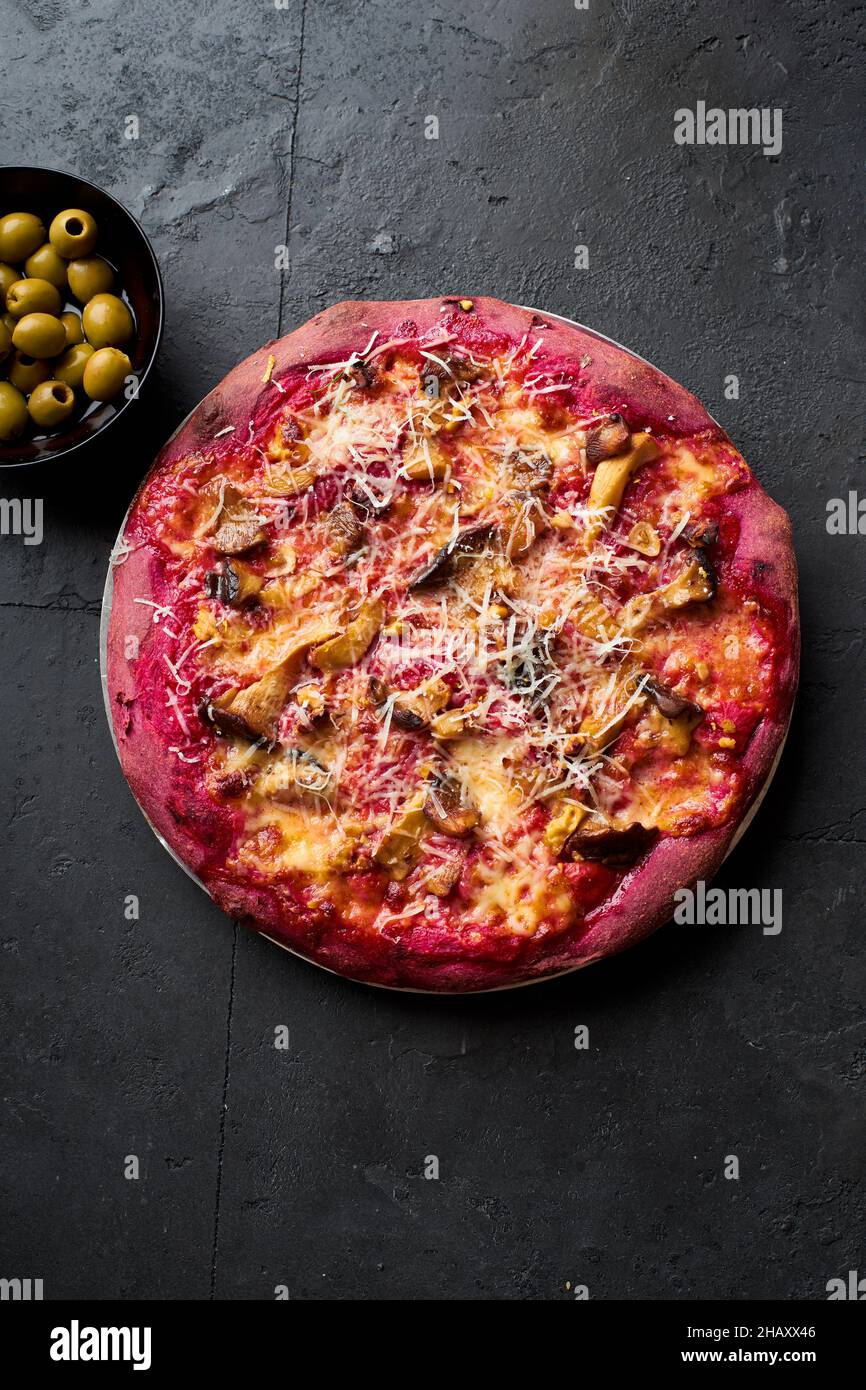 Purple colored rustic pizza with beetroot and vegetarian topping. Top ...