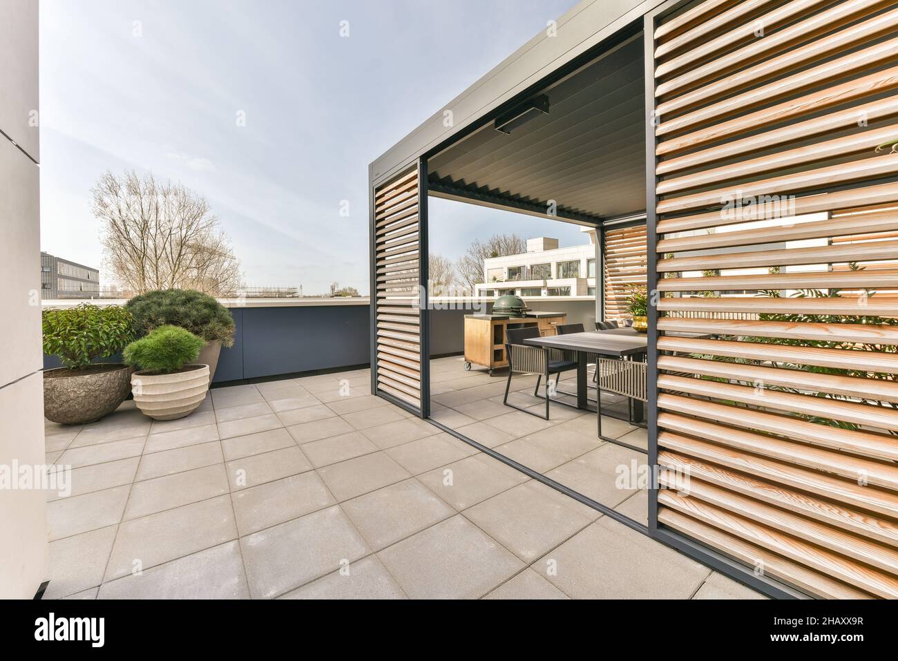 Exterior of spacious modern terrace with dining table with chairs ...