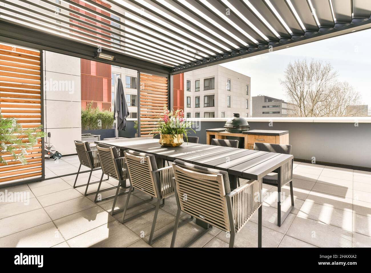 Exterior of spacious modern terrace with dining table with chairs ...