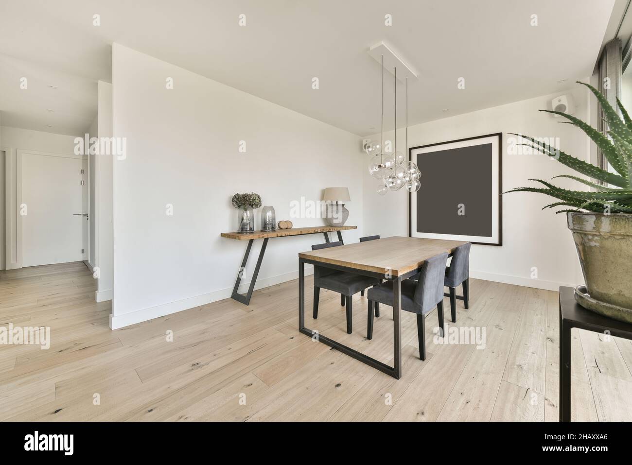 Wooden table with comfortable chairs placed in spacious light dining ...