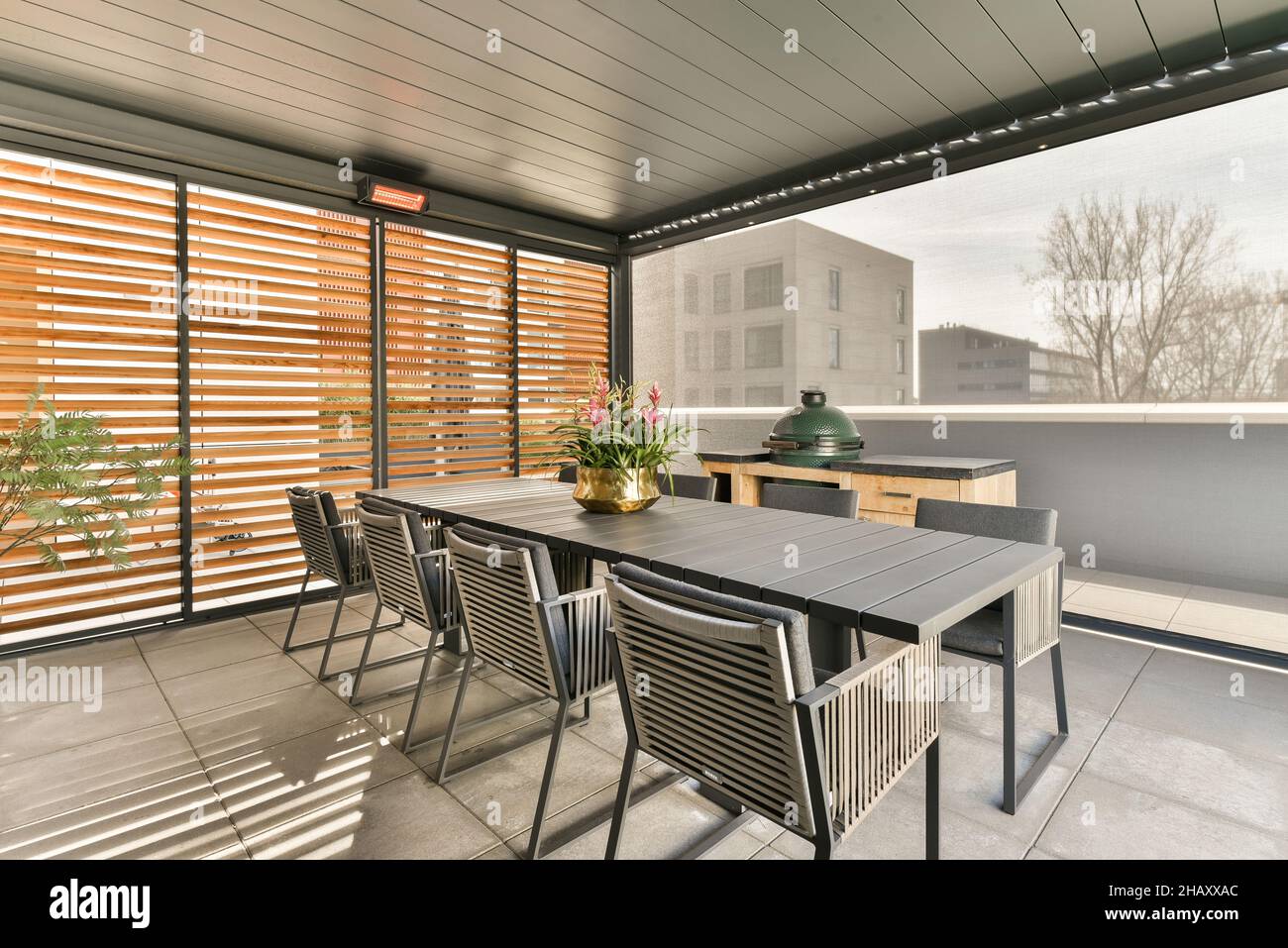 Exterior of spacious modern terrace with dining table with chairs ...