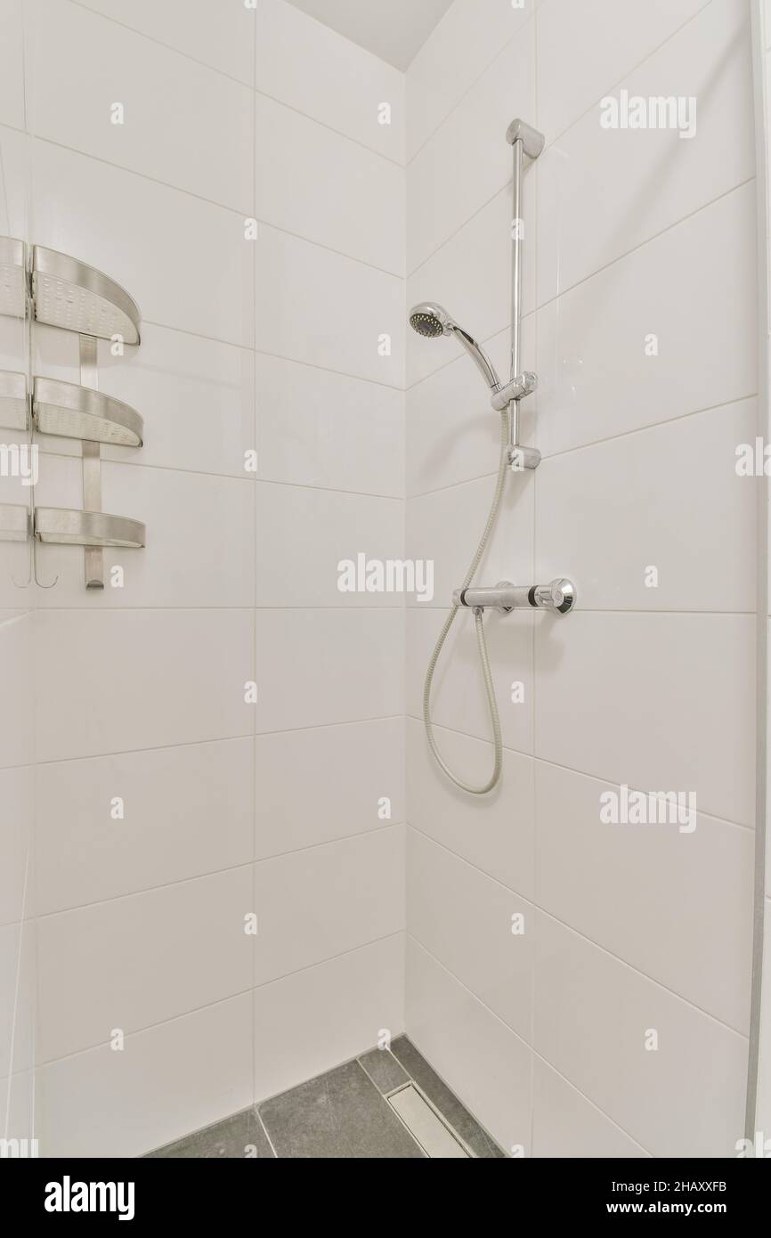 Interior of bathroom with empty shower cabin with light tiled walls in ...