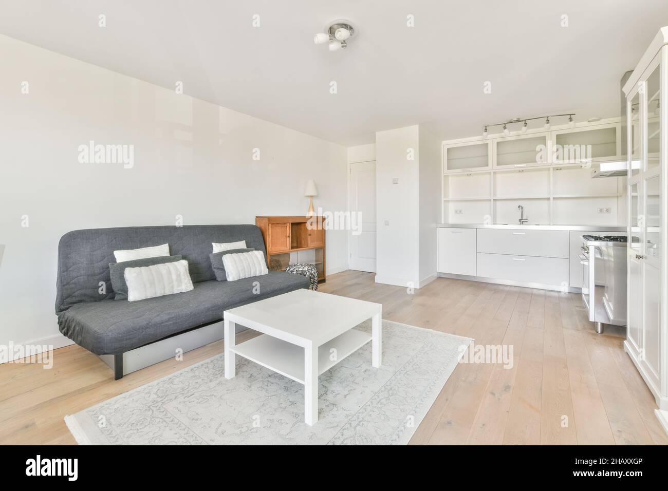 Interior of white spacious open plan room furnished with tables and ...