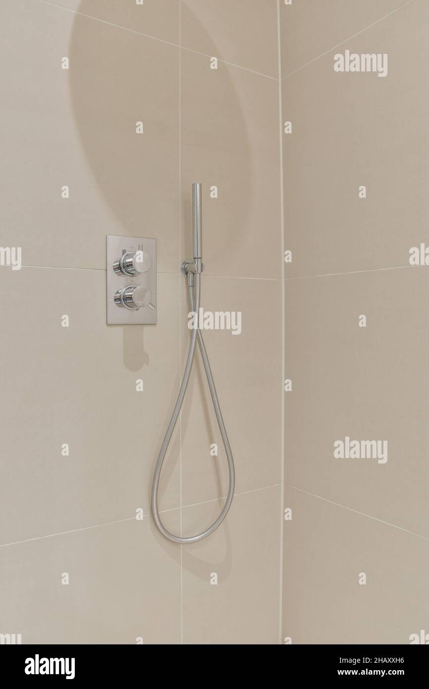 Interior of bathroom with empty shower cabin with light tiled walls in ...