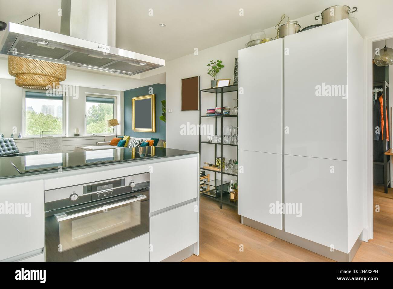 Kitchen counter with contemporary oven and stove under extract hood ...