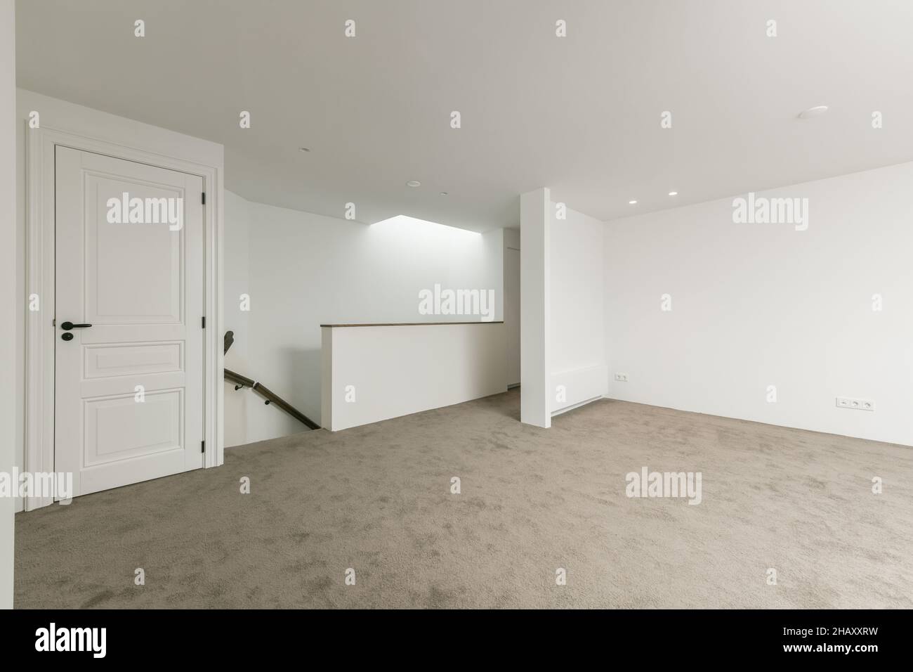 Interior of spacious empty basement space in house with white walls and ...