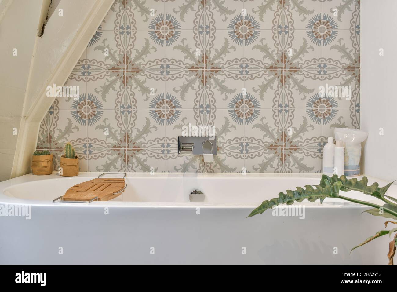 Interior of stylish bathroom with ornamental tiled walls light blue ...