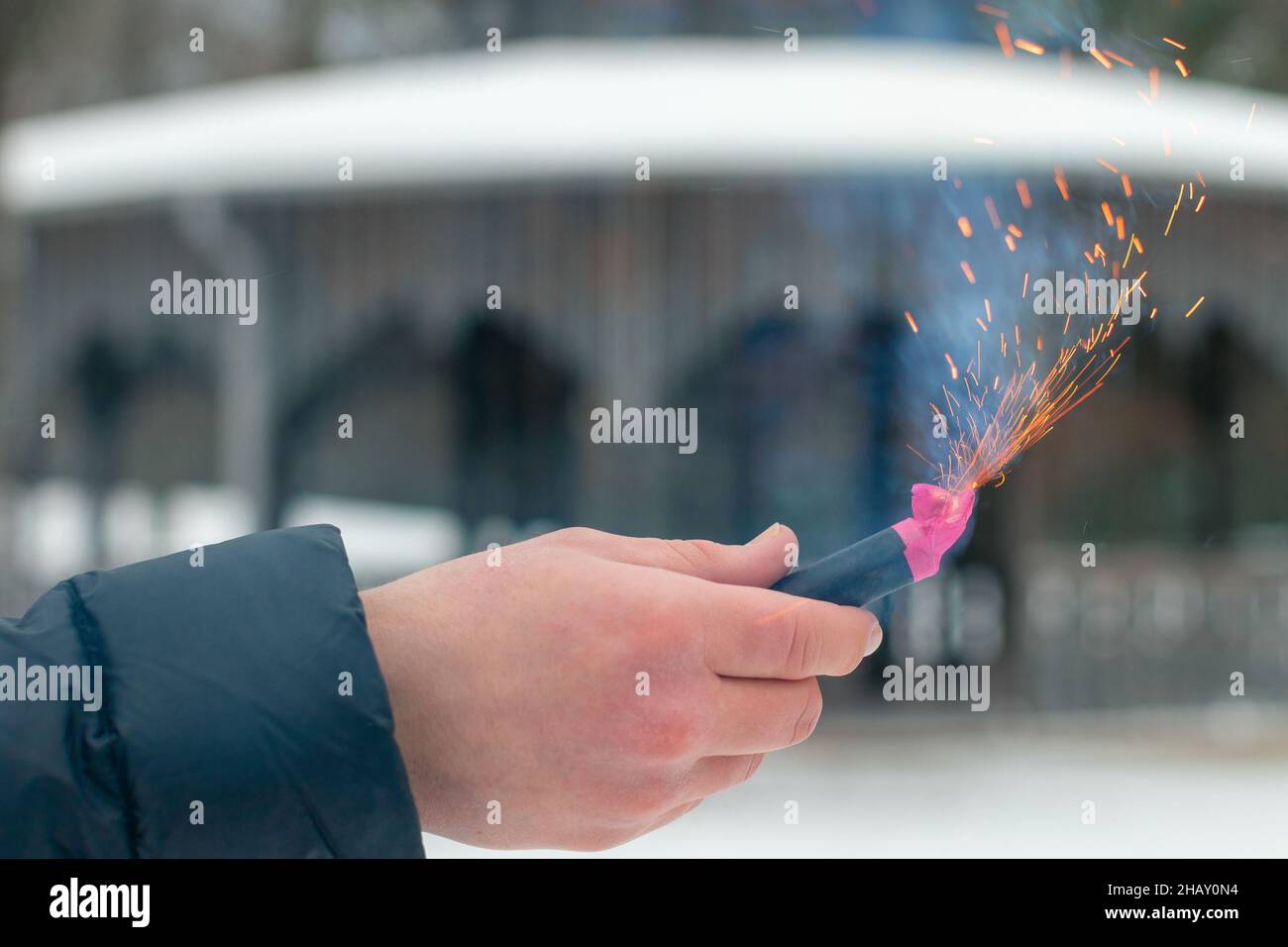 Burning Firecracker in a Hand. Guy Holding a Petard Outdoors in Winter ...