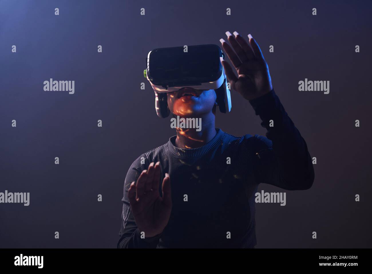 African American female in modern VR headset standing on black ...