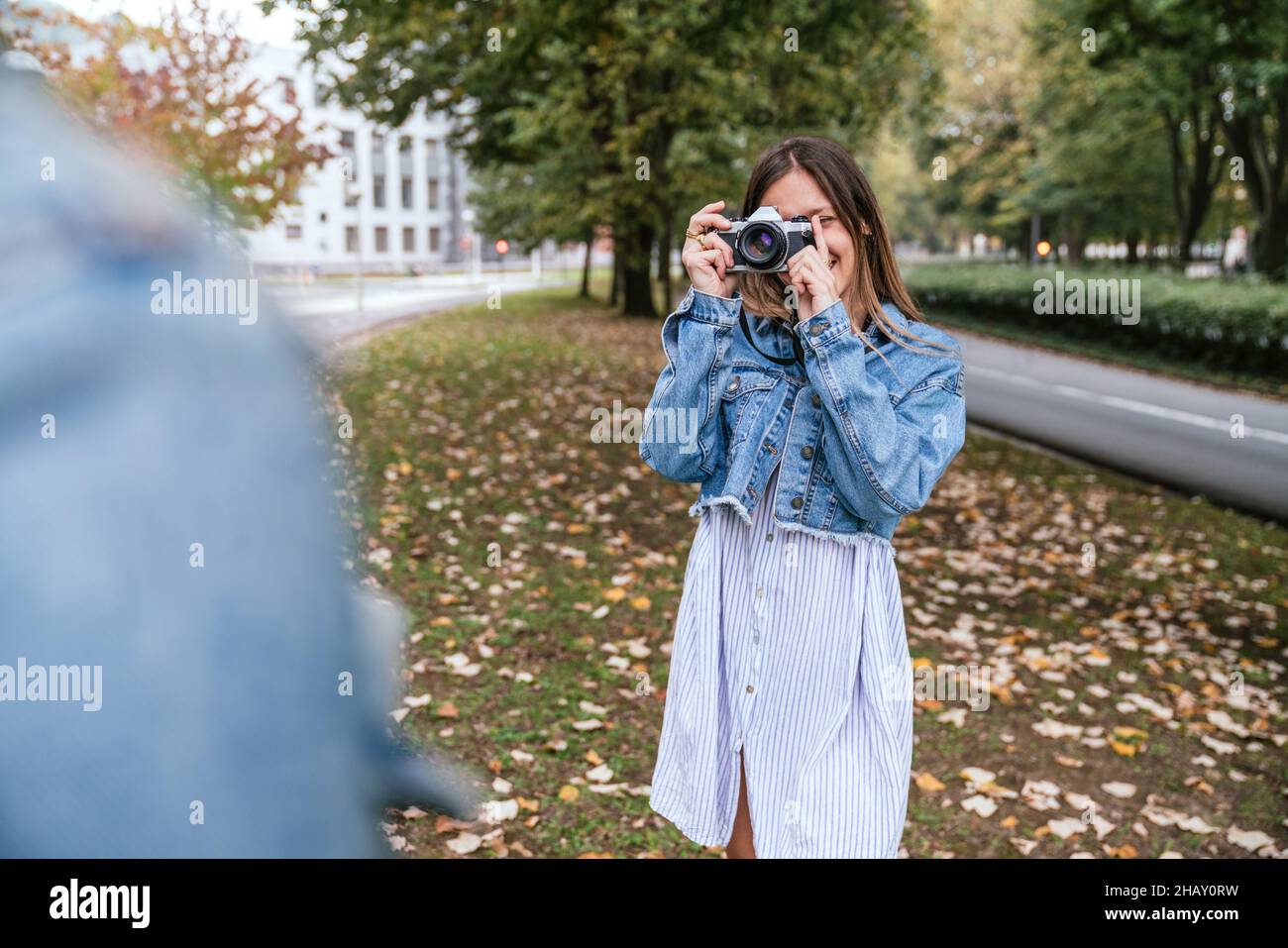 Faceless female photographer taking photo of crop anonymous friend on ...