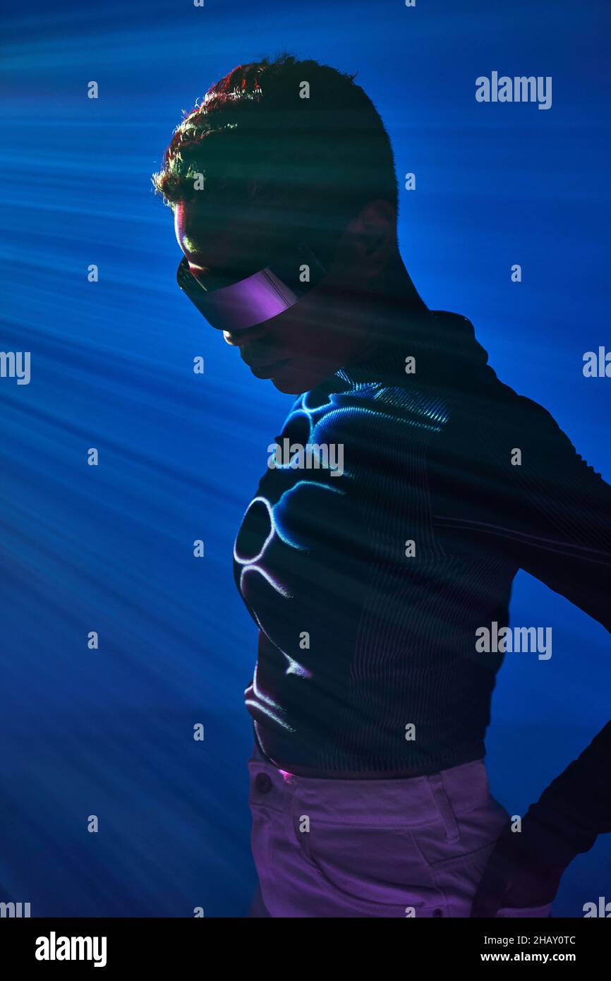 Side view of futuristic African American female in headset of virtual ...
