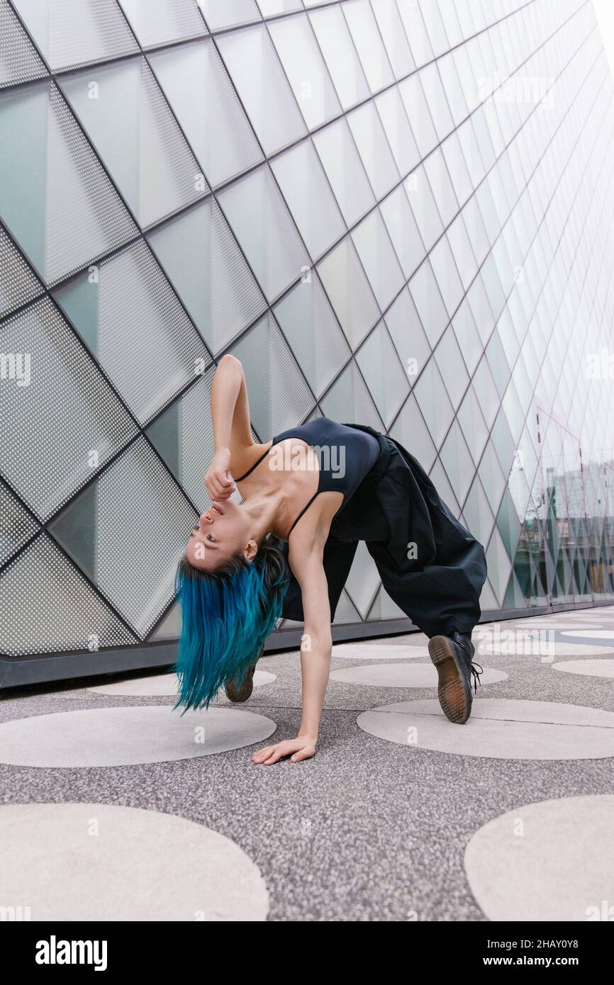 Young Woman with blue hair in black outfit performing contemporary ...